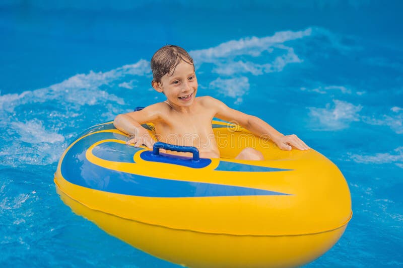 Boy on a Pool Float on Artificial Waves in a Water Park Stock Photo ...