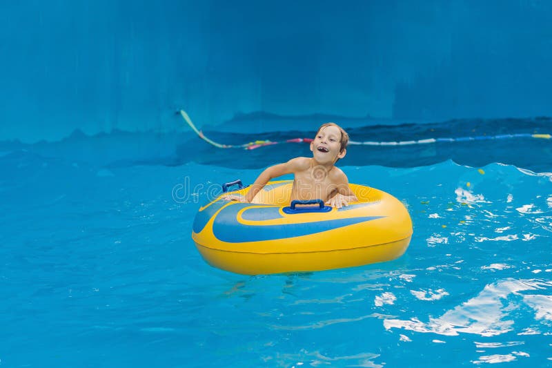 Boy on a Pool Float on Artificial Waves in a Water Park Stock Image ...