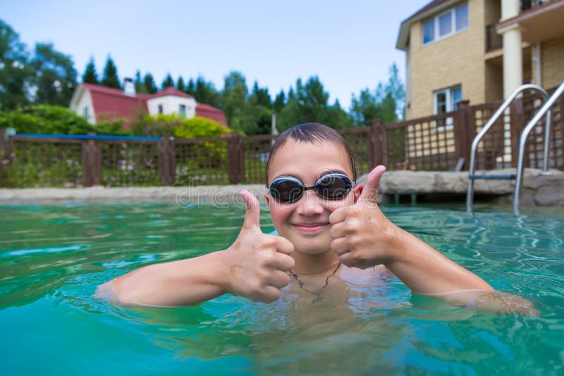 Boy in the pool outdoors stock image. Image of summer - 34803749
