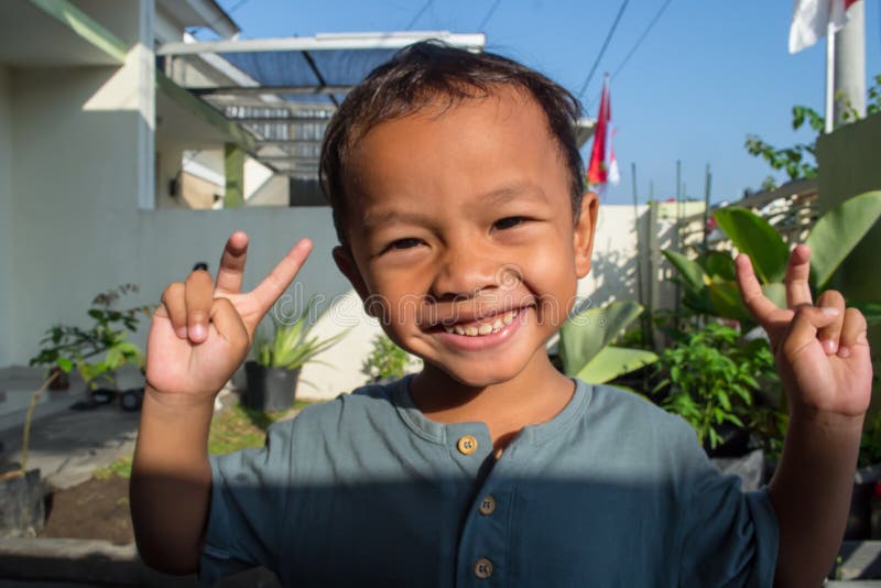 A Boy is Posing Adorable in His Yard Stock Photo - Image of posing ...