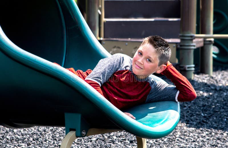 Boy Posing at the Bottom of a Slide Stock Image - Image of playing ...