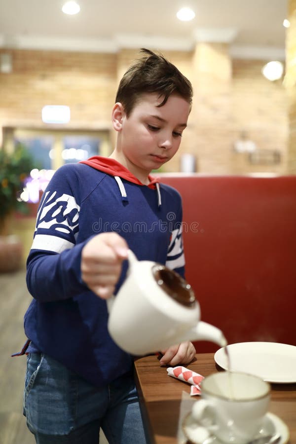 Boy Pouring Tea in Restaurant Stock Image - Image of dining, drinking ...