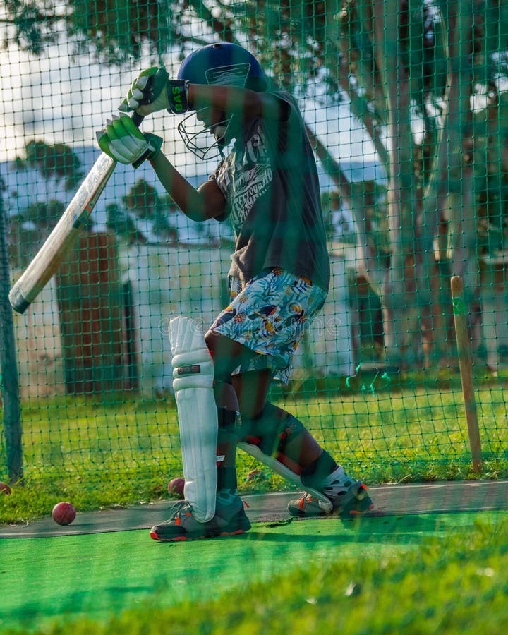 Boy Practicing Cricket with Protective Gear Stock Photo - Image of ...