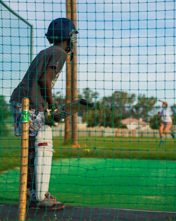 Boy Practicing Cricket with Protective Gear Stock Image - Image of ...