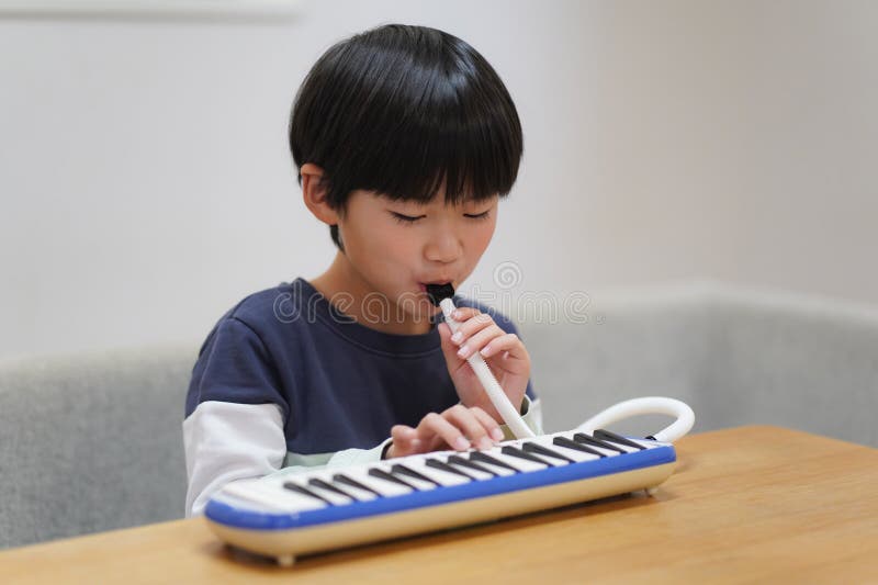 Boy Practicing Keyboard Harmonica Stock Image - Image of japanese ...