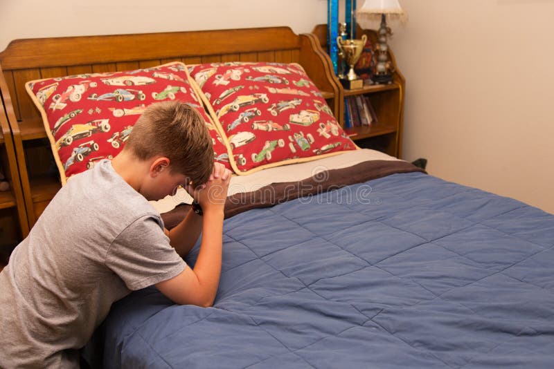 Boy Praying in his bedroom stock photo. Image of religion - 76973482