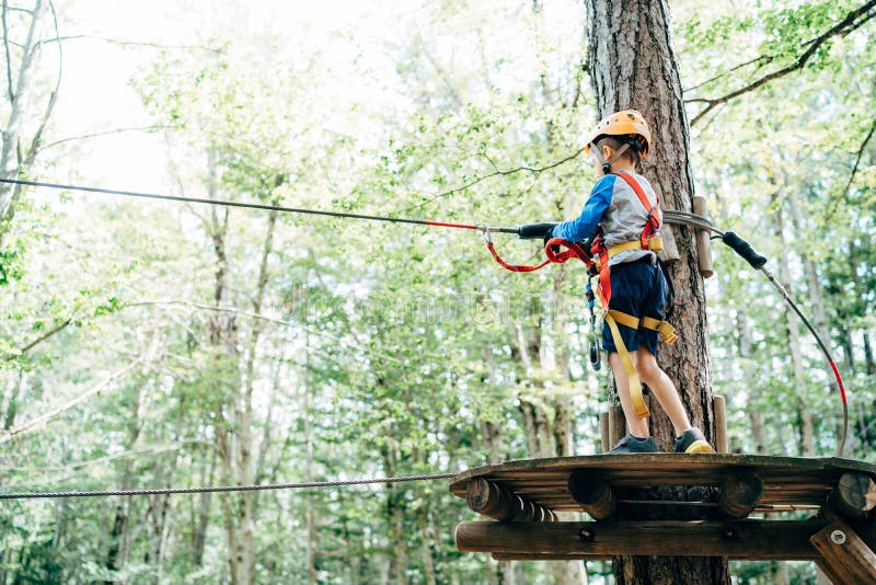 Boy Prepares for Walking on the Zip Line between the Trees Stock Image ...