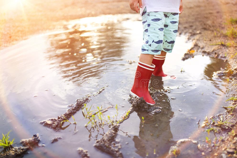 Boy in a puddle stock image. Image of spring, green, outside - 50906371