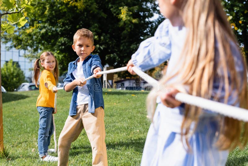 Boy Pulling Rope while Playing Tug Stock Image - Image of kids, park ...