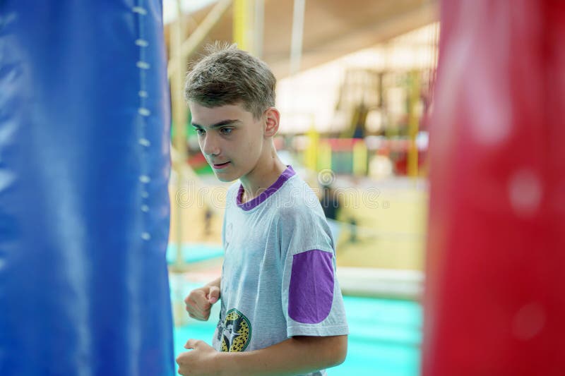 A Boy Punches a Punching Bag at a Play Park Stock Image - Image of ...