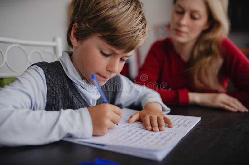 Boy Pupil Doing His Homework at Home with His Mother Stock Photo ...