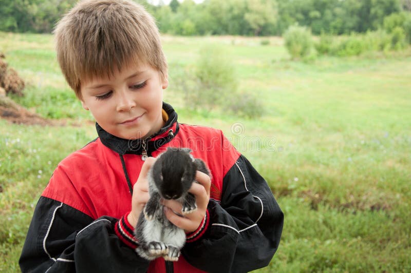 A boy with a rabbit stock photo. Image of black, park - 21263694