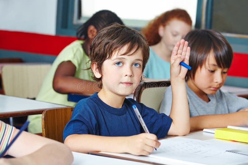 Boy Raising Hand in Elementary Stock Photo - Image of children, pencil ...