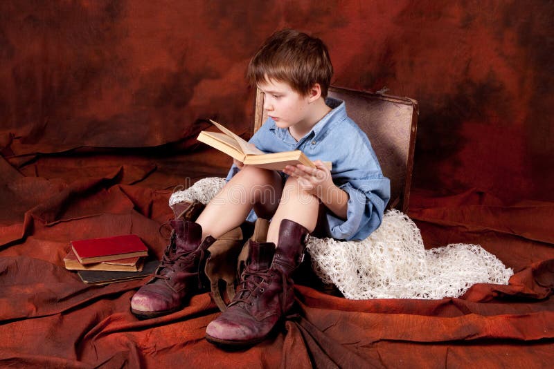 A boy reading a book stock photo. Image of book, blue - 12952368