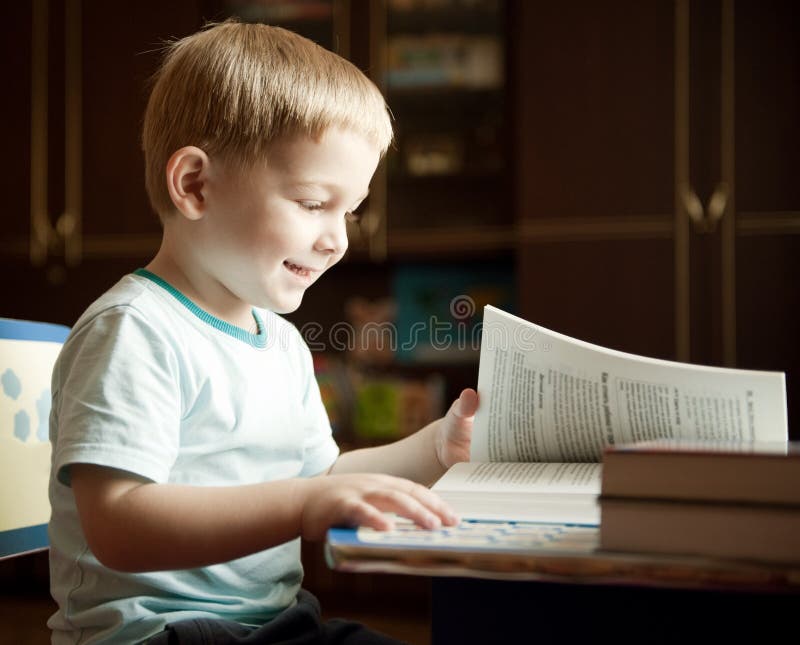 Boy reading book stock image. Image of home, expression - 21550337