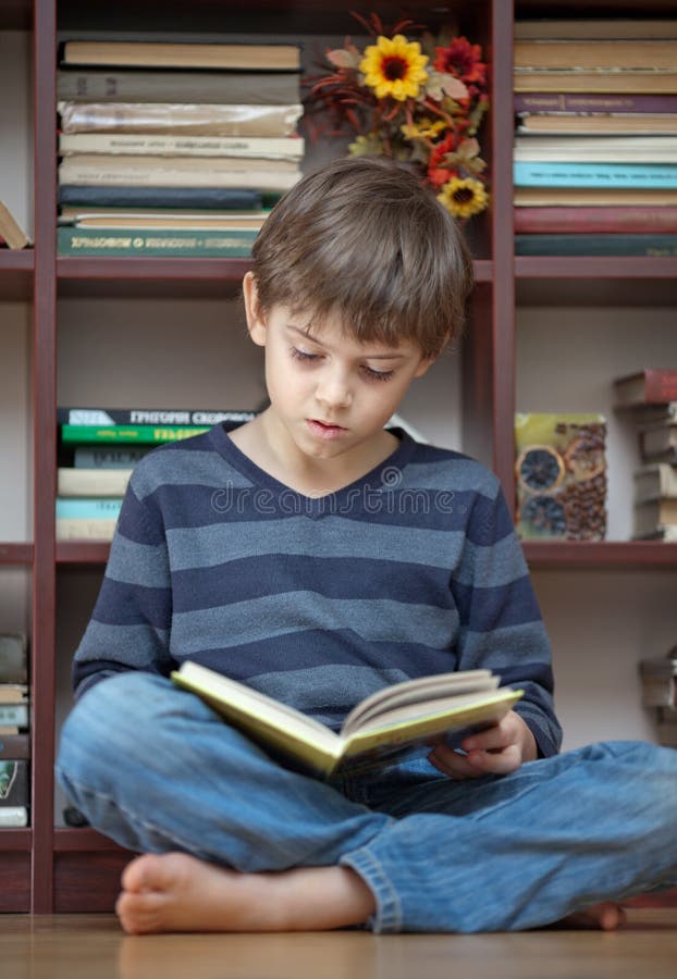 Boy reading a book stock photo. Image of looking, books - 23676148