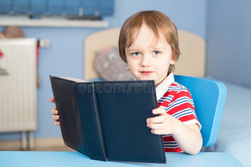 Boy is reading a book stock photo. Image of reading, book - 28180548