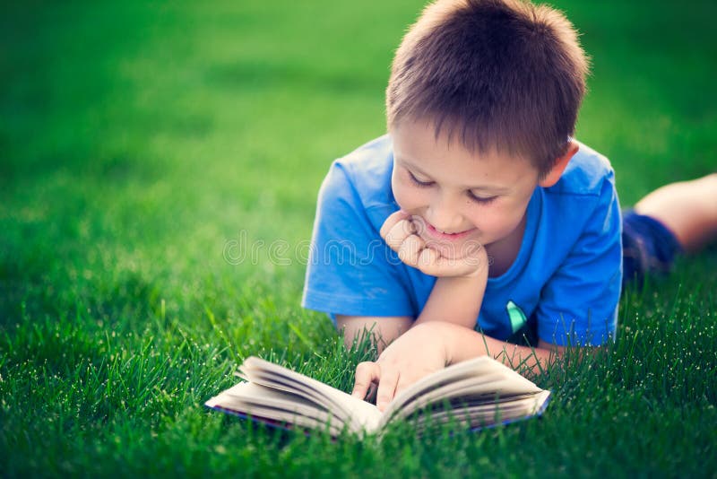 Boy Reading Book on Green Grass Stock Image - Image of summer, light ...