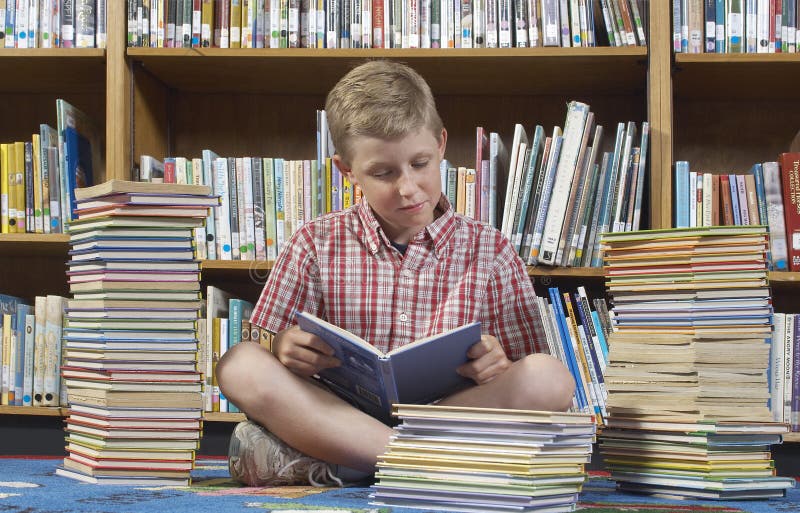 Boy Reading Book in Library Stock Photo - Image of children, book: 29662070