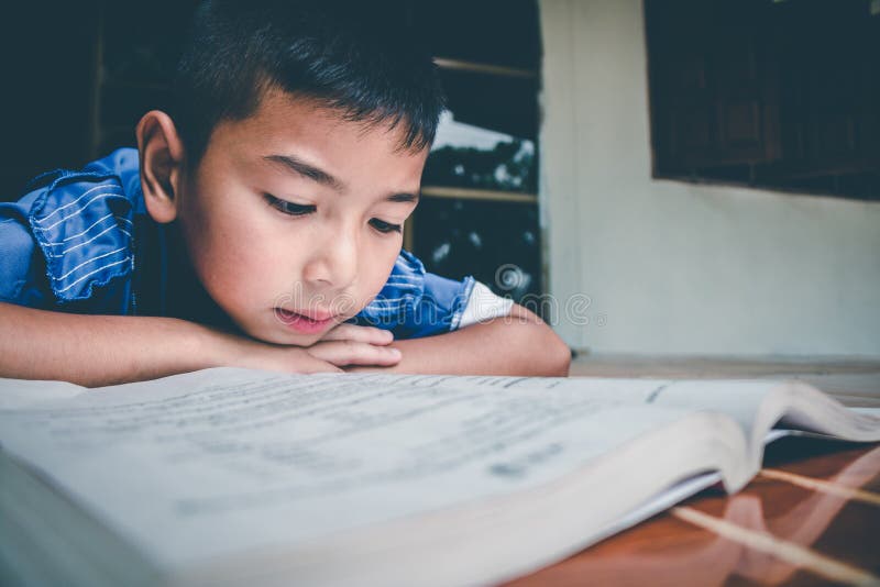 The Boy is Reading the Book for Prepare the Exam on this Coming Monday ...