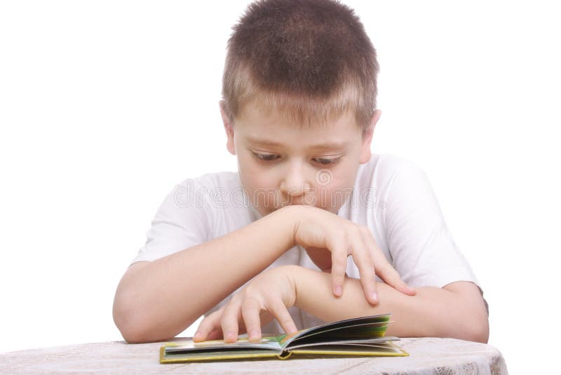Boy reading book at table stock photo. Image of horizontal - 13478372