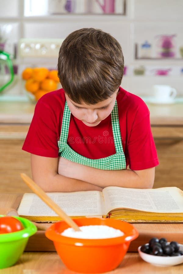 Boy Reading the Cook Book for Making the Dinner Stock Photo - Image of ...