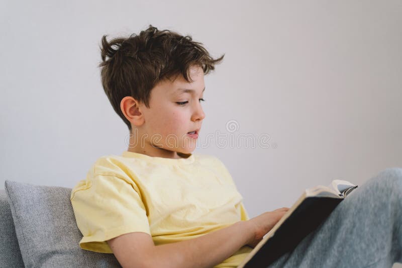 Boy Reading an Interesting Book Stock Photo - Image of focused ...