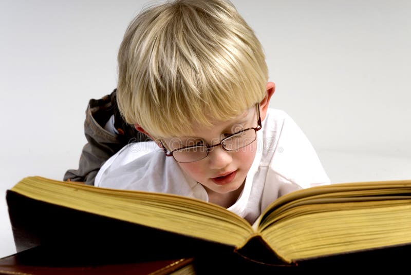 Boy is reading thick books stock photo. Image of reading - 2016644