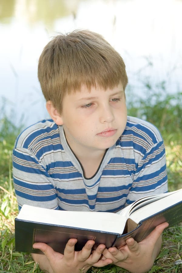 Boy Reading a Book at the Park Stock Photo - Image of relax, curious ...