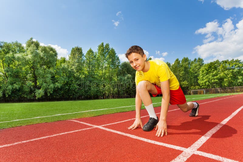 Boy in Ready Position on One Bend Knee To Run Stock Image - Image of ...
