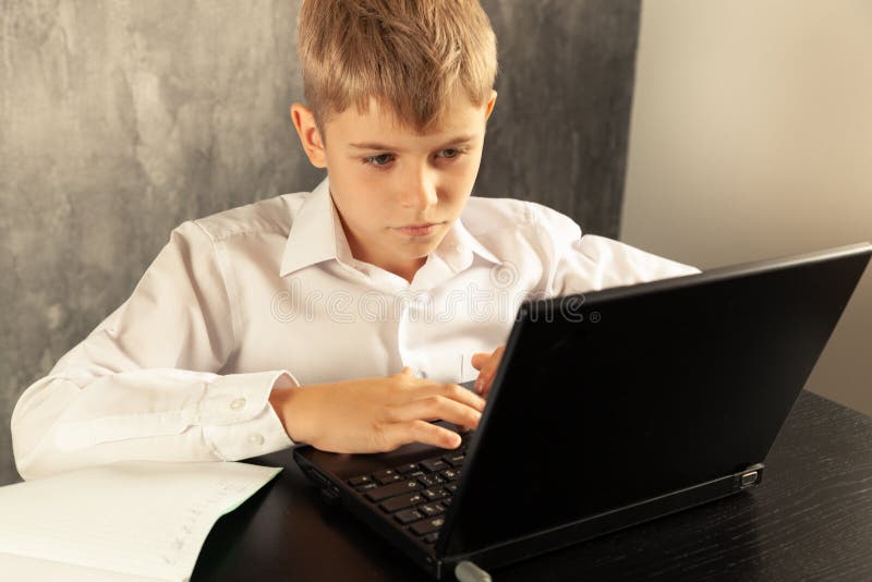 The Boy Receives Education Remotely Using a Computer. Back To School ...