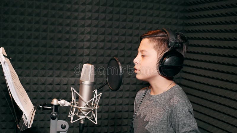 A Boy is Recording a Song in a Recording Studio. the Boy in the ...