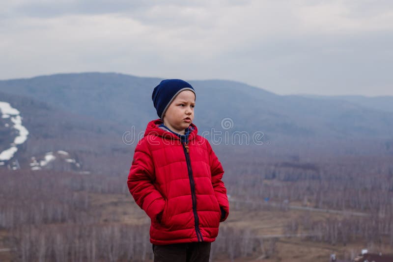 Boy in a Red Jacket in the Misty Mountains Stock Photo - Image of ...