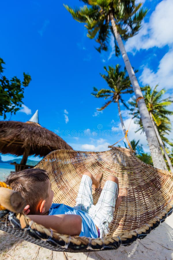 Boy relaxing on a beach. stock photo. Image of beach - 69453458