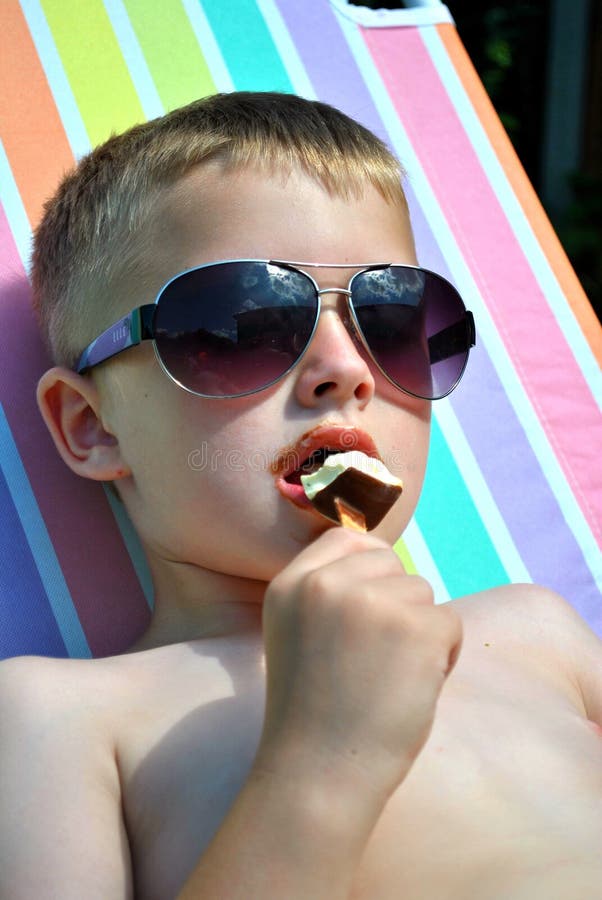 Boy Relaxing on the Sun Bed Stock Image - Image of lounger, relax: 43102327