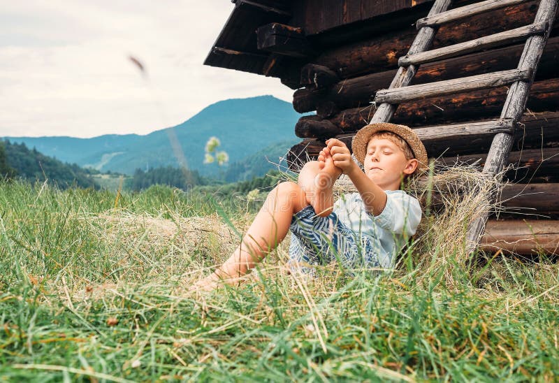 Boy Rest in Green Grass Under Hayloft in Summer Afternoon Stock Image ...