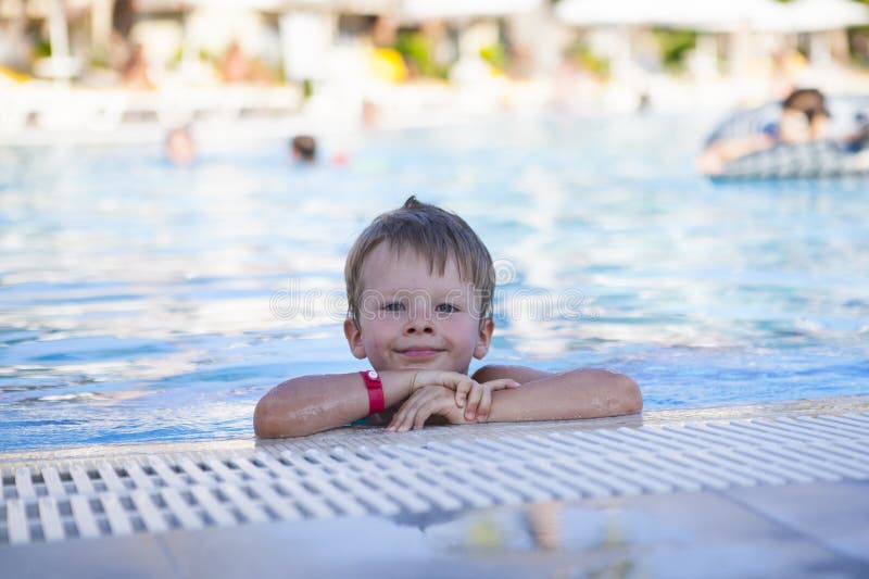 Boy resting by pool stock image. Image of positive, beverage - 137483519