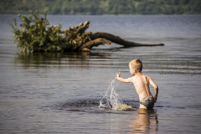 Boy resting in the river stock photo. Image of summer - 74237438