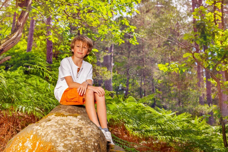 Boy Resting on the Stone in Forest after Hike Stock Photo - Image of ...