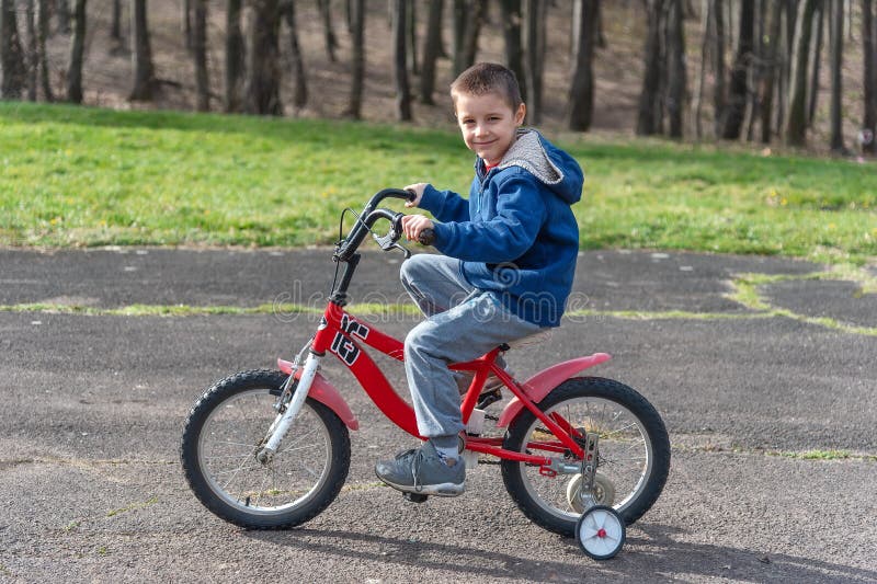 The boy rides a bicycle stock photo. Image of horizontal - 213417516