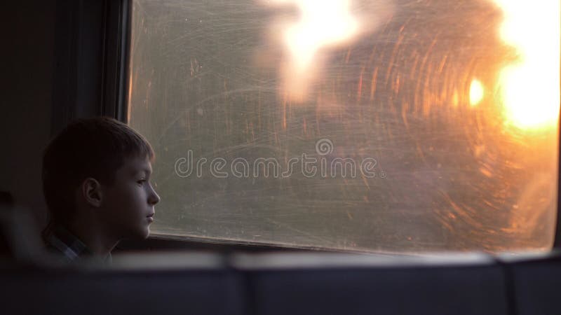 Boy Rides on a Train in the Evening Looks Out the Window Stock Image ...
