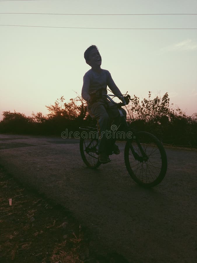 Boy Riding of Bicycle stock image. Image of landscape - 109919027