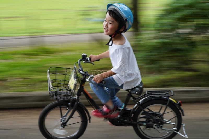 A boy riding a bicycle stock image. Image of hobbies - 238365955