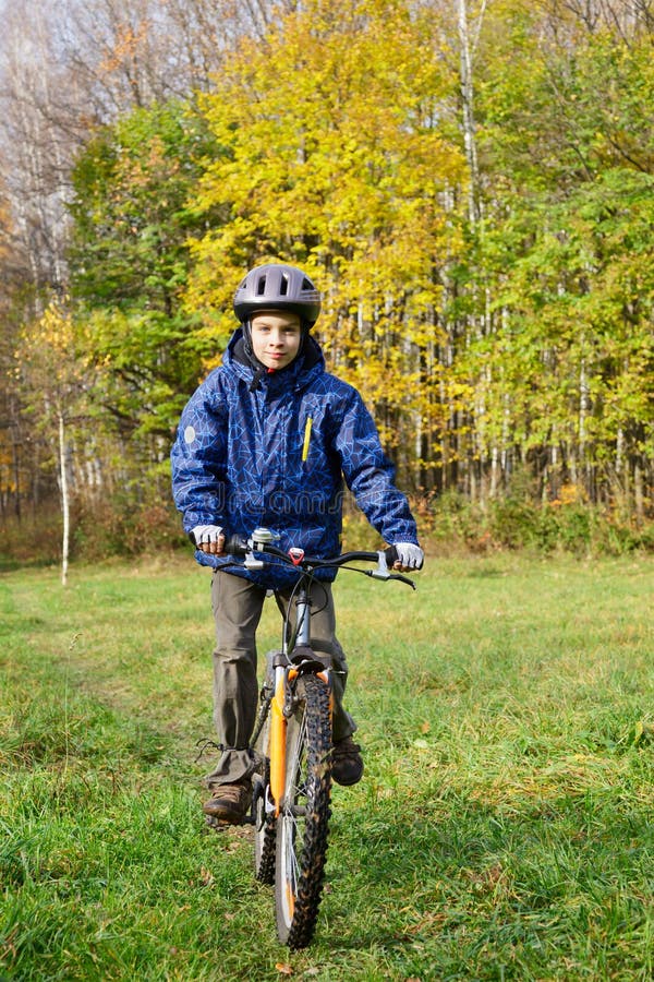 Boy Riding Bicycle in a Park Stock Photo - Image of outdoors, enjoyment ...