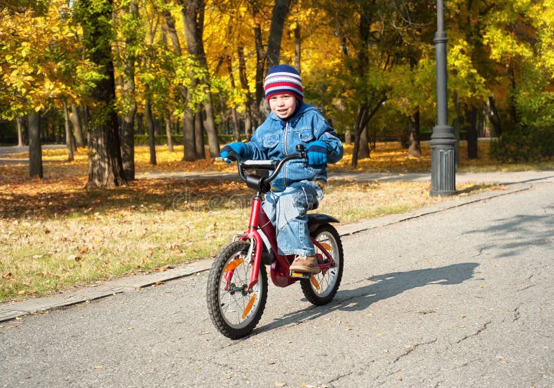 Boy Riding on Bicycle in Park Stock Image - Image of outdoors, outdoor ...