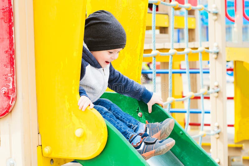 Energetic Boy Playing on the Slide Stock Photo - Image of years, little ...