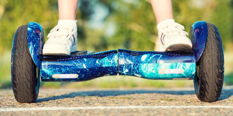 The Boy is Riding on a Gyroboard.Legs on Hover Board. Stock Photo ...