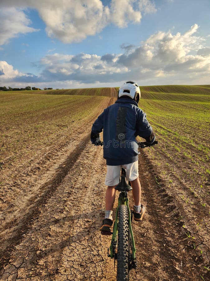 A Boy Riding His Mountain Bike in the Field Stock Image - Image of ...