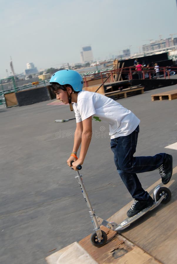 Boy riding his Scooter stock image. Image of park, child - 17010591