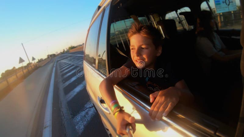 Boy is Riding in the Passenger Seat in the Car and Looking Happily at ...